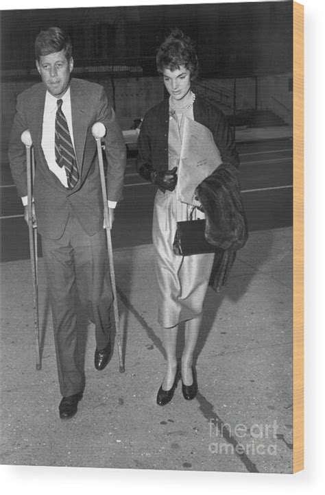 John F Kennedy On Crutches With Wife Wood Print By Bettmann