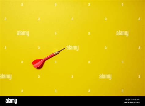 Single Red Arrow Dart Isolated On Yellow Background Stock Photo Alamy