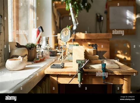 Background Image Of Jewelers Workstation With Wooden Table Lit By