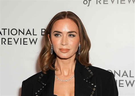 Emily Blunt Covers Her Cheeky Ultra Plunging Bodysuit With Nothing But