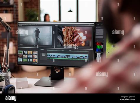 Male Videographer Editing Video Montage On Post Production Software Working On Computer