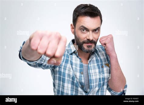 Handsome Man Punching With Fist At Camera Isolated On A White