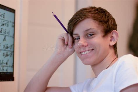 A Teenage Boy Solves Mathematical Problems At The Computer The Student