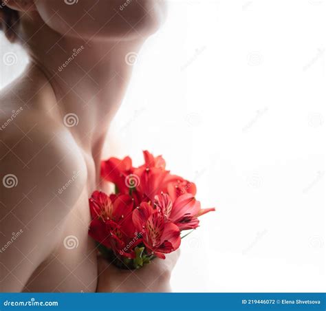 A Naked Girl In Defocus Holds A Bouquet Of Red Alstroemeria Front View Selective Focus Stock