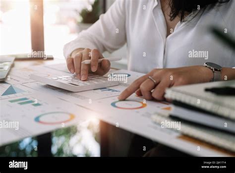 Business Woman Working On Desk Office With Calculator To Calculate The Numbers Finance