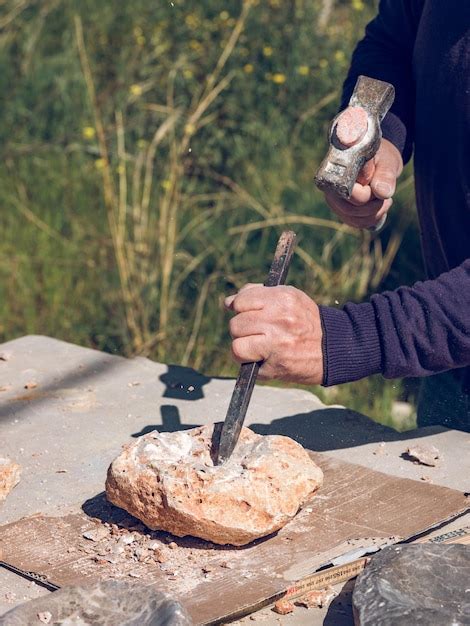 Premium Photo From Above Of Crop Anonymous Craftsman Cutting Solid Rock Using Sharp Chisel And