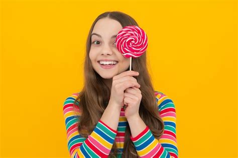 Premium Photo Teenager Girl Eating Sugar Lollypop Candy And Sweets