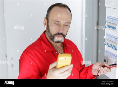 Electrician Testing Fusebox With Multimeter Stock Photo Alamy