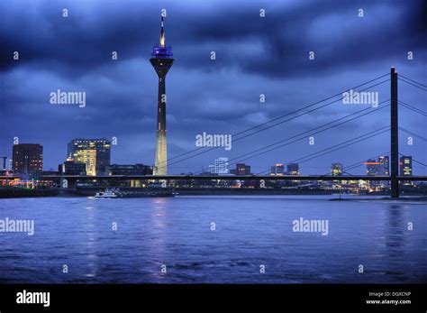 Rheinturm Tower With The Rhine And The Skyline At Dusk Medienhafen