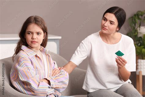 Mother Talking With Her Teenage Daughter About Contraception At Home