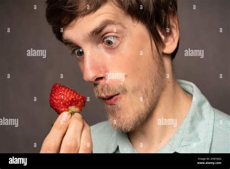 Young Handsome Tall Slim White Man With Brown Hair Holding Half Eaten