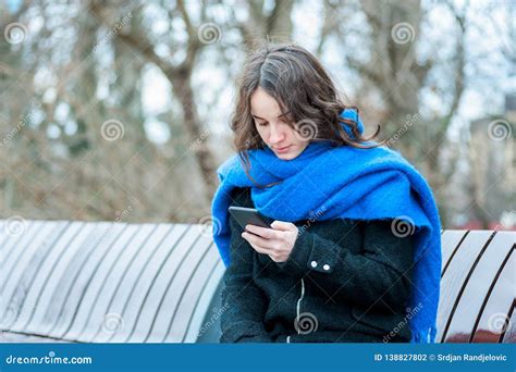 One Lonely Beautiful Girl Sitting Alone And Depressed On The Bench In