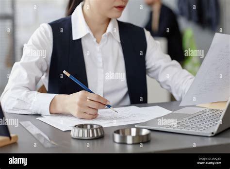 Closeup Of Female Engineer Using Computer At Workplace In Office And Designing Blueprints Stock