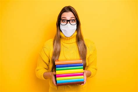 Portrait Of Nice Healthy Stunned Girl Nerd Wearing Safety Mask Holding In Hands Pile Book Learn