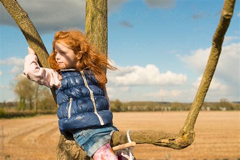 Girl Climbing Tree In Countryside By Stocksy Contributor Craig Holmes Stocksy