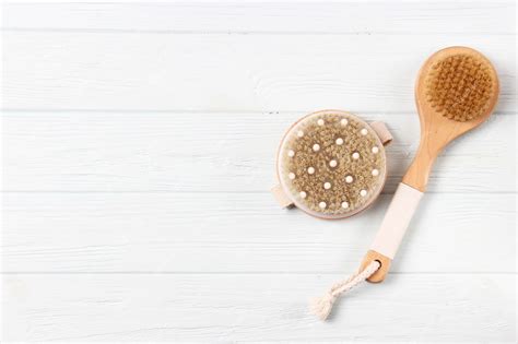 Premium Photo Brush For Dry Massage On A Colored Background Top View