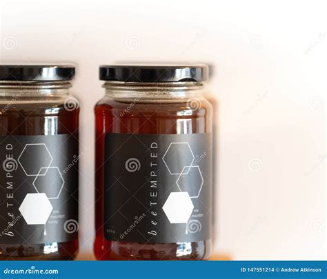 Honey In Glass Jars With Black Lids For Sale On Shop Shelves Editorial