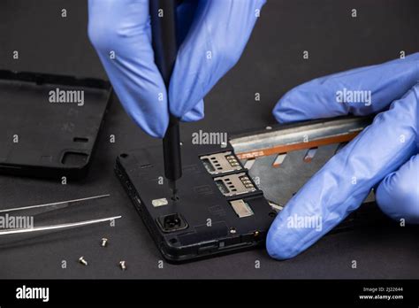 Process Of Mobile Phone Repair Hands Of A Service Worker Repairing Modern Mobile Phone Stock