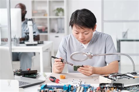 Premium Photo Asian Woman In Uniform Soldering Circuit Board