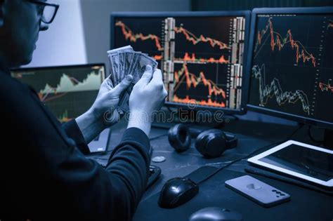 Financial Analyst Working On A Computer With Multi Monitor Workstation