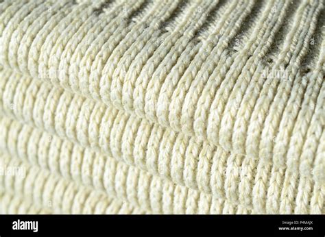 composition of a soft yellow knitted sweater macro texture of bindings