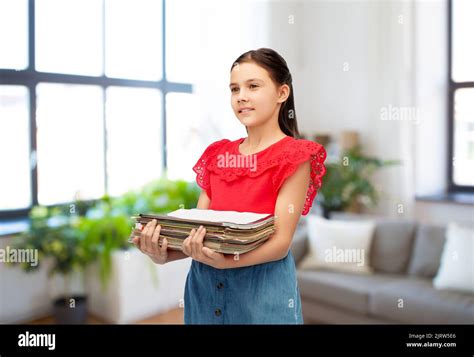 Girl With Magazines Sorting Paper Waste At Home Stock Photo Alamy