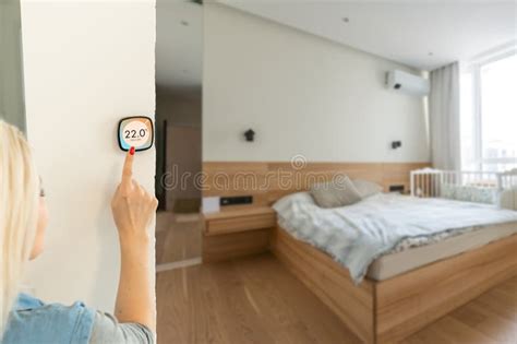 Smiling Indian Woman Using Modern Smart Home System Controller On Wall Positive Attractive