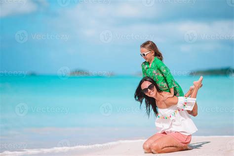 Beautiful Mother And Daughter At Caribbean Beach Enjoying Summer