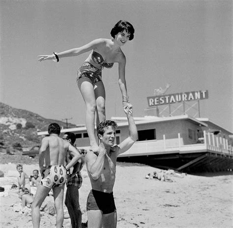 Natalie Wood Standing On Steve Rowlands Shoulders At A Beach In Malibu