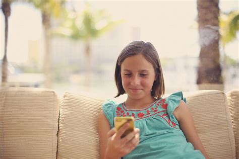 Tween Girl Smiling At Her Phone By Stocksy Contributor Alicia Bock Stocksy