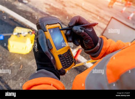 site engineer operating his touch screen controller instrument during