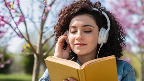 Premium Photo A Woman With Headphones Reading A Book And Listening To