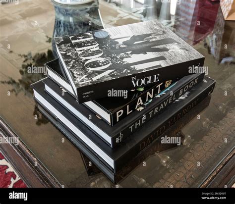 Both Stylish And Statement Books On Top Of A Bespoke Glass Topped Table