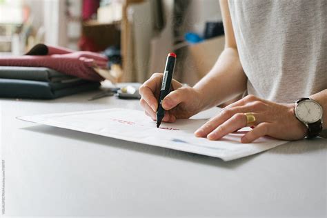 Caucasian Woman Writing Address With Red Marker On White Envelope By Stocksy Contributor