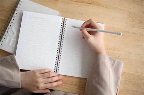 Premium Photo Female Writing An Essay Taking Notes Doing Homework Listing Things On Spiral
