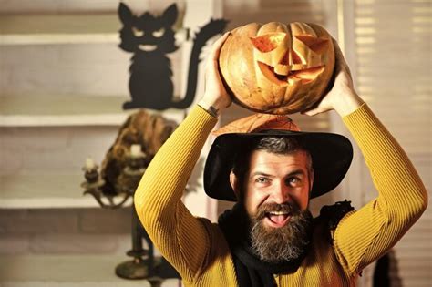 Premium Photo Wizard In Black Witch Hat On Spooky Room Background