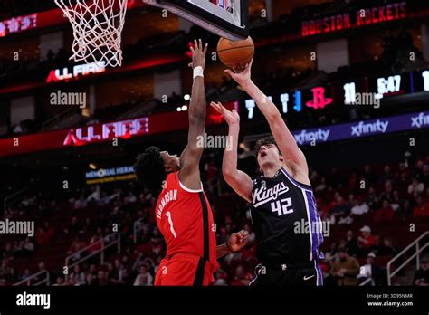 Sacramento Kings Center Maxime Raynaud 42 Shoots Against Houston Rockets Guard Amen Thompson