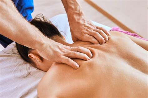 Deep Tissue Massage Therapy For Young Caucasian Woman Lying Face Down