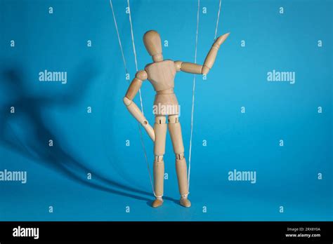 One Wooden Puppet With Strings On Light Blue Background Stock Photo Alamy