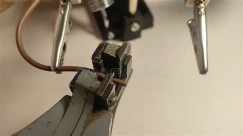 An Electrician Removes Insulation From Electrical Wiring With A Special Tool With A Stripper