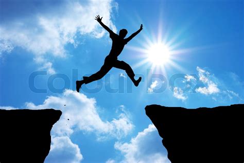 Man Jump Through The Gap Stock Image Colourbox