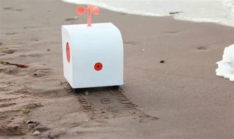 This Adorable AI Robot Spends Its Day Scribbling Poems In The Sand