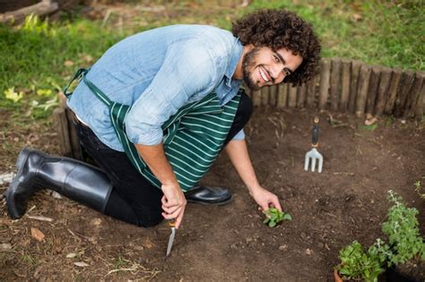 Premium Photo Gardener Planting Outside Greenhouse