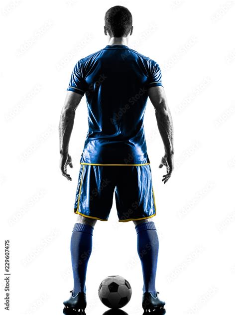 One Caucasian Soccer Player Man Standing Rear View In Silhouette Isolated On White Background