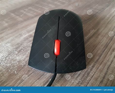 Black Computer Mouse With Red Scroll Button On Wooden Table One Part Of The Computer Stock
