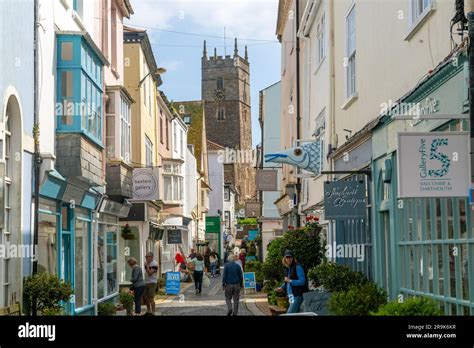 Shops In Historic Buildings Along Alleyway With Tower Of Church Of St