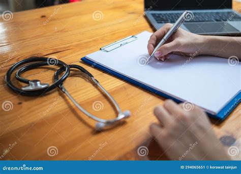 Female Doctor Is Reviewing Documents To Review And Diagnose Illness And Female Doctor Has