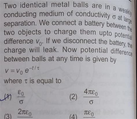 Answered Two Identical Metal Balls Are In A Weakly Conducting Medium
