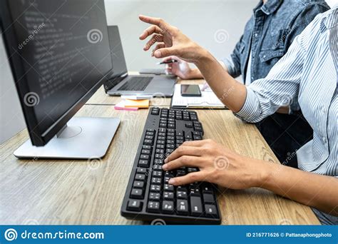 Two Professional Programmer Cooperating And Working On Web Site Project In A Software Developing