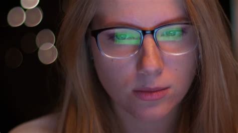 Close Up Footage Of Spectacled Caucasian Blonde Woman Looking At Computer Screen And It Is